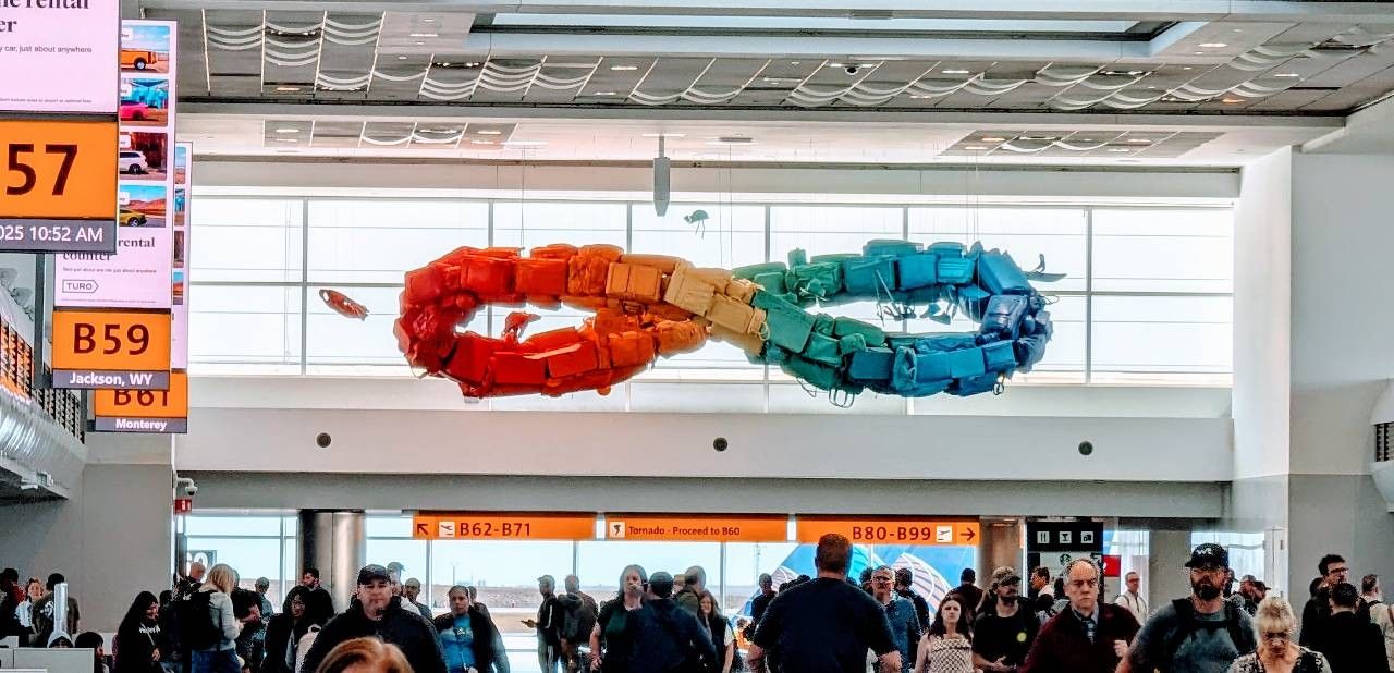 Newish art installation at DEN (Concourse B) made of old suitcases. 💜 ...